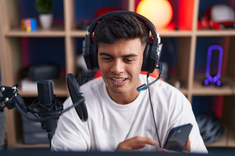 Young Hispanic Man Streamer Using Computer and Smartphone at Gaming ...