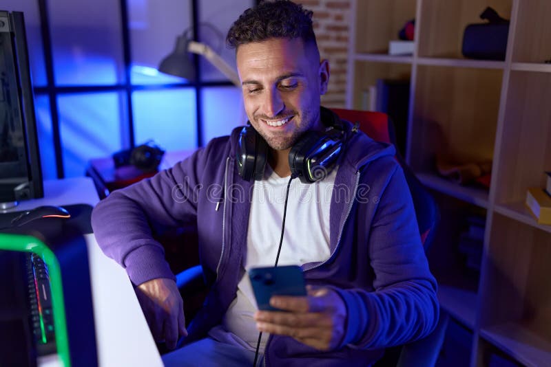 Young Hispanic Man Streamer Using Computer and Smartphone at Gaming ...