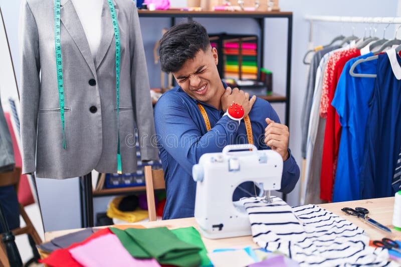 Young Hispanic Man Tailor Stressed Using Sewing Machine at Clothing ...
