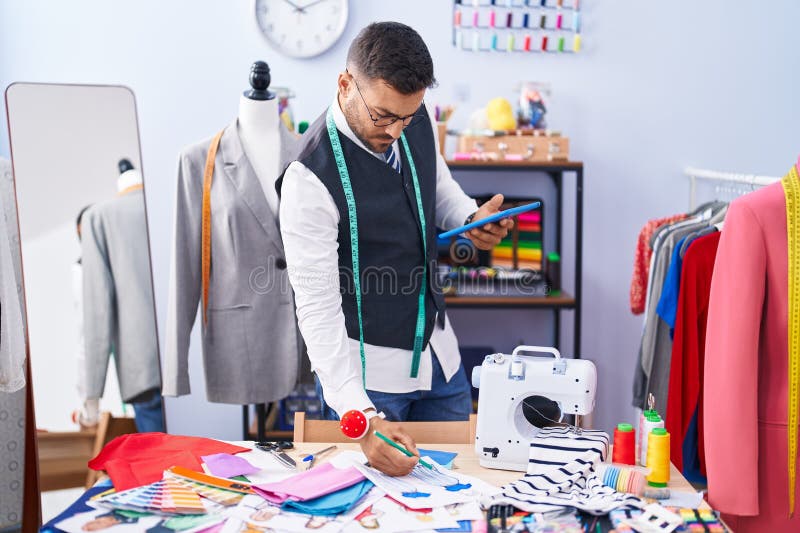 Young Hispanic Man Tailor Using Touchpad Drawing Clothing Design at ...
