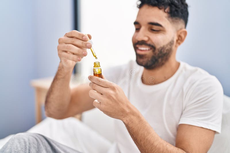 Young Hispanic Man Taking Syrup Sitting on Bed at Bedroom Stock Image ...