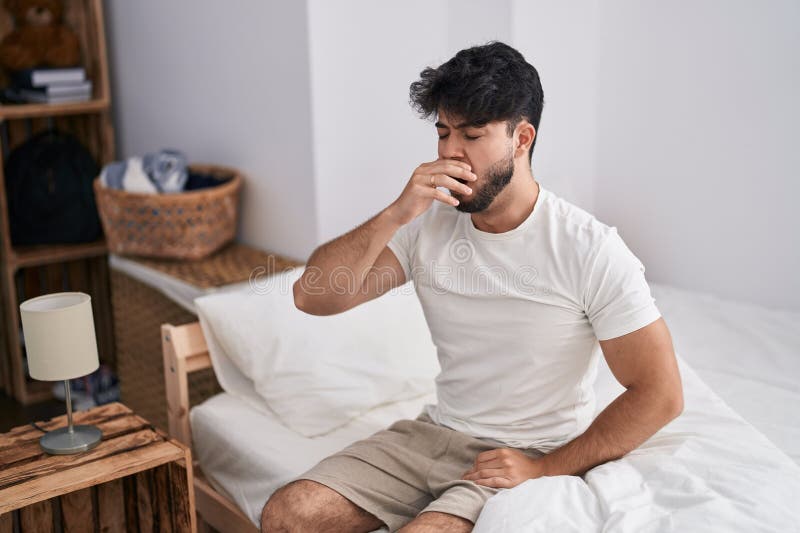 Young Hispanic Man Tired Sitting on Bed at Bedroom Stock Image - Image ...