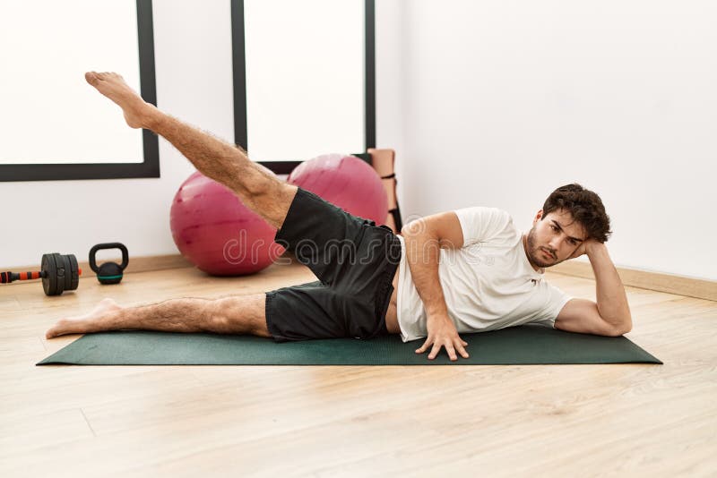 Young Hispanic Man Training Abs Exercise at Sport Center Stock Photo ...