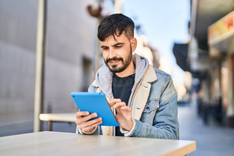 Young Hispanic Man Using Touchpad Sitting on Table at Coffee Shop ...
