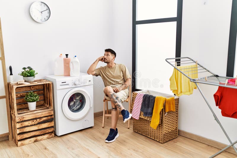 Young Hispanic Man Waiting for Washing Machine at Laundry Room Stock ...