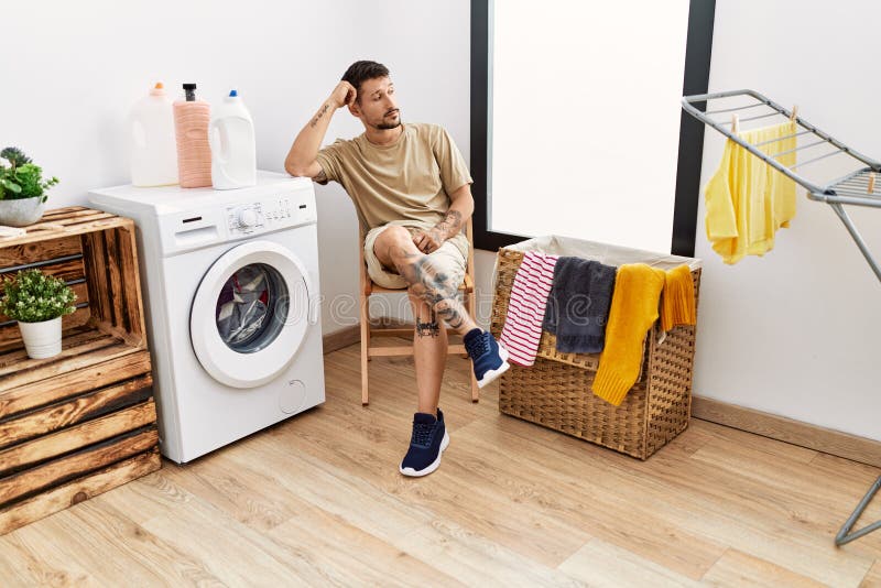Young Hispanic Man Waiting for Washing Machine at Laundry Room Stock ...