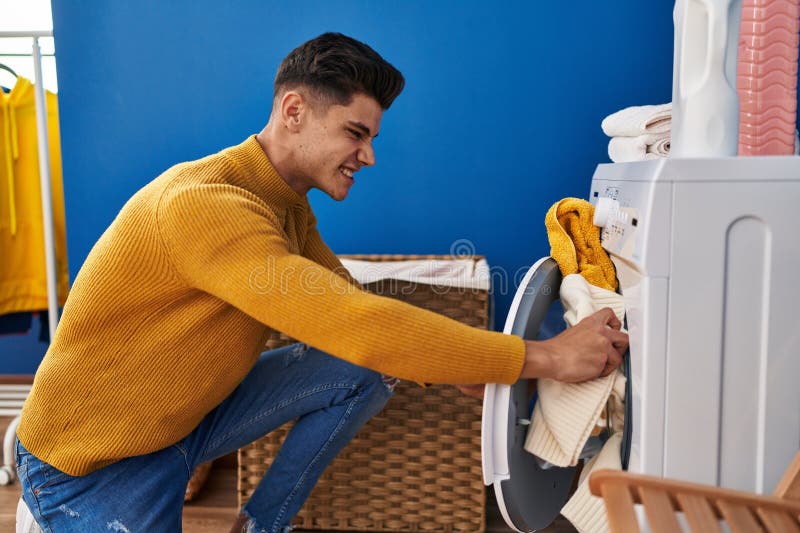 Young Hispanic Man Washing Clothes at Laundry Stock Image - Image of ...
