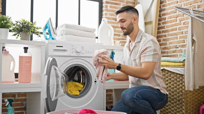Young Hispanic Man Washing Clothes at Laundry Room Stock Image - Image ...