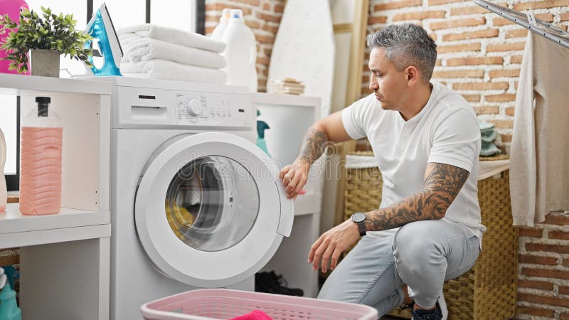 Young Hispanic Man Washing Clothes at Laundry Room Stock Image - Image ...