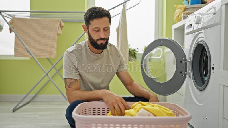 Young Hispanic Man Washing Clothes at Laundry Room Stock Photo - Image ...