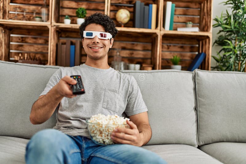 Young Hispanic Man Watching Movie Using 3d Glasses Sitting on the Sofa ...