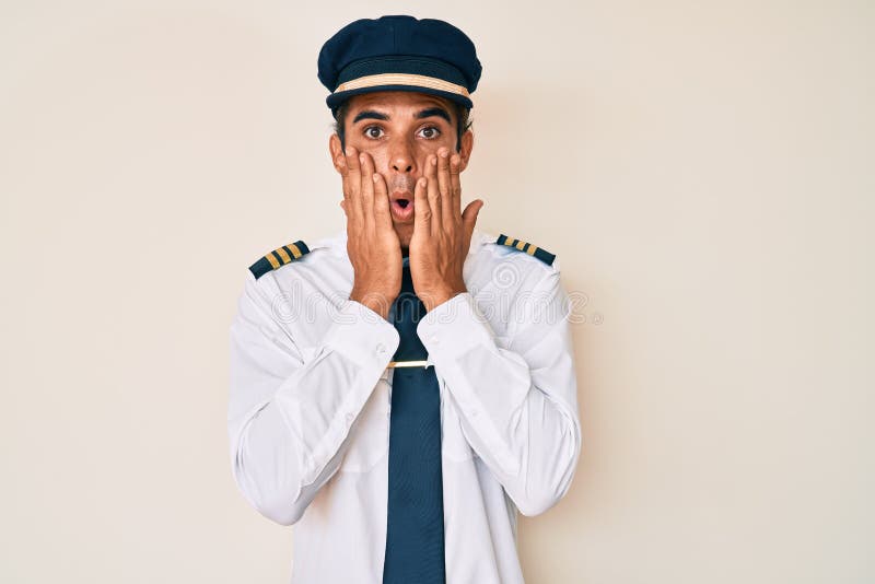 Handsome Hispanic Man Wearing Airplane Pilot Uniform Afraid Shocked ...