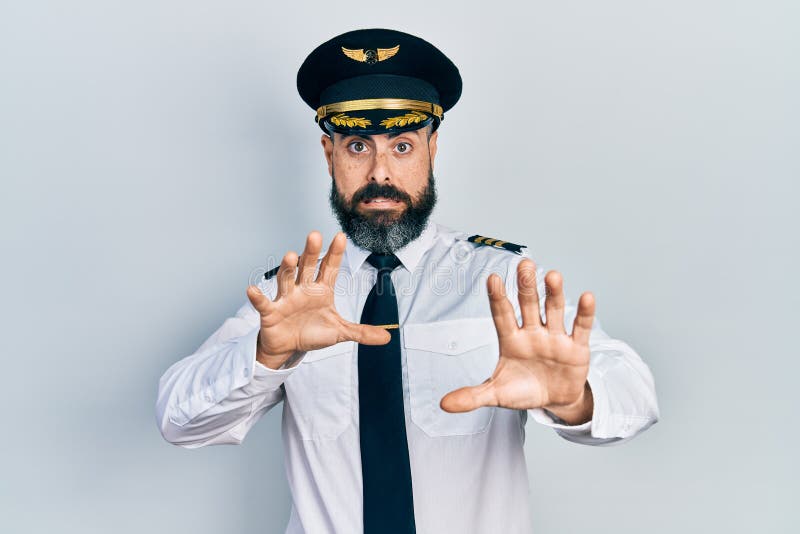 Young Hispanic Man Wearing Airplane Pilot Uniform Afraid and Terrified ...