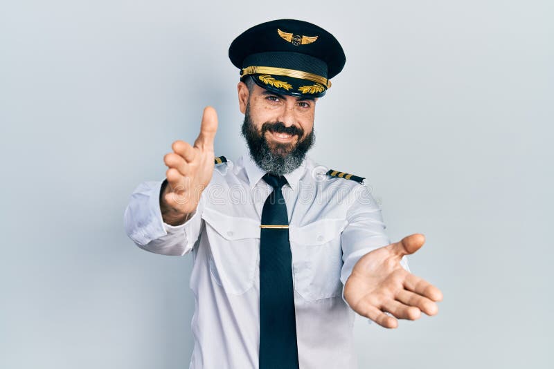 Young Hispanic Man Wearing Airplane Pilot Uniform Looking at the Camera ...