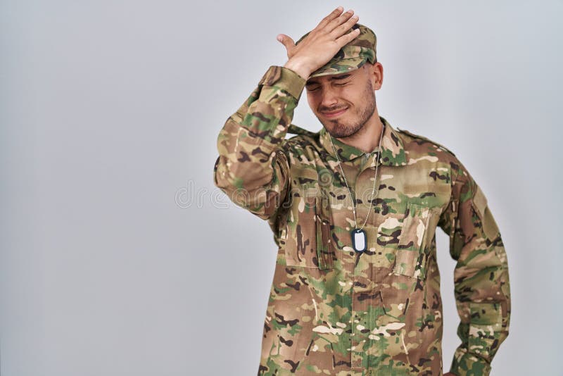 Young Hispanic Man Wearing Camouflage Army Uniform Surprised with Hand ...