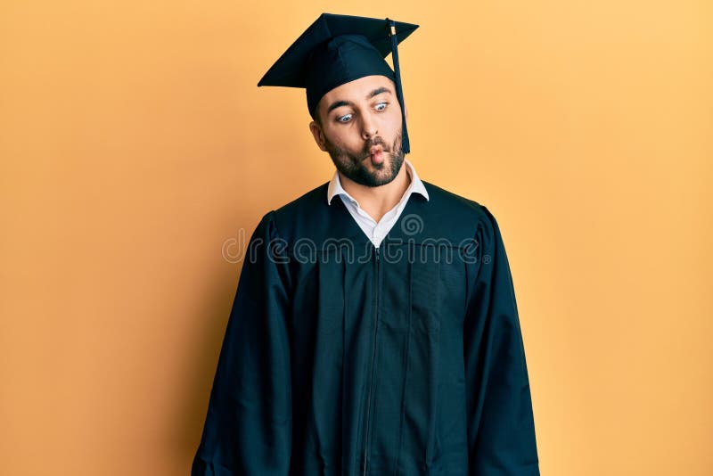 Young Hispanic Man Wearing Graduation Cap and Ceremony Robe Making Fish ...