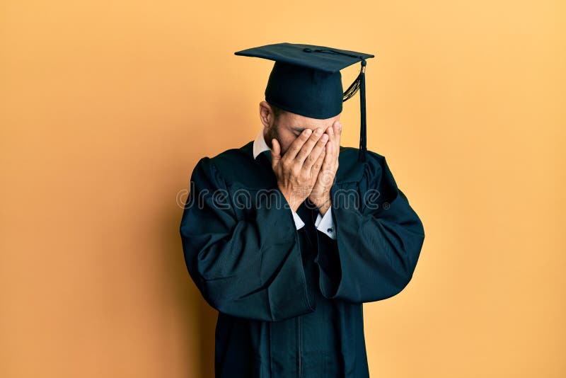 Young Hispanic Man Wearing Graduation Cap and Ceremony Robe with Sad ...