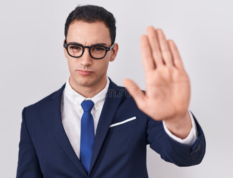 Young Hispanic Man Wearing Suit and Tie Doing Stop Sing with Palm of ...