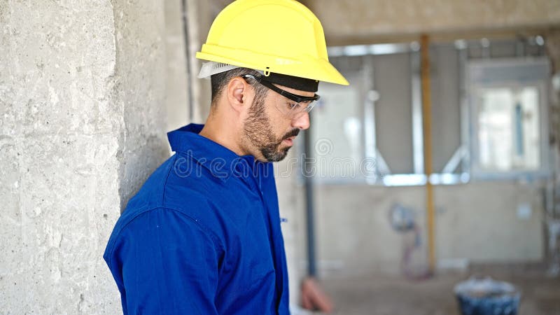 Young Hispanic Man Worker Leaning on Wall Tired at Construction Site ...
