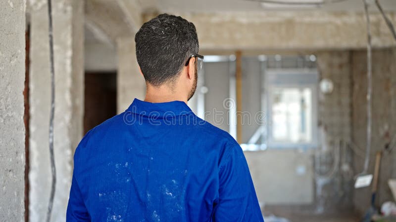 Young Hispanic Man Worker Standing Backwards at Construction Site Stock ...