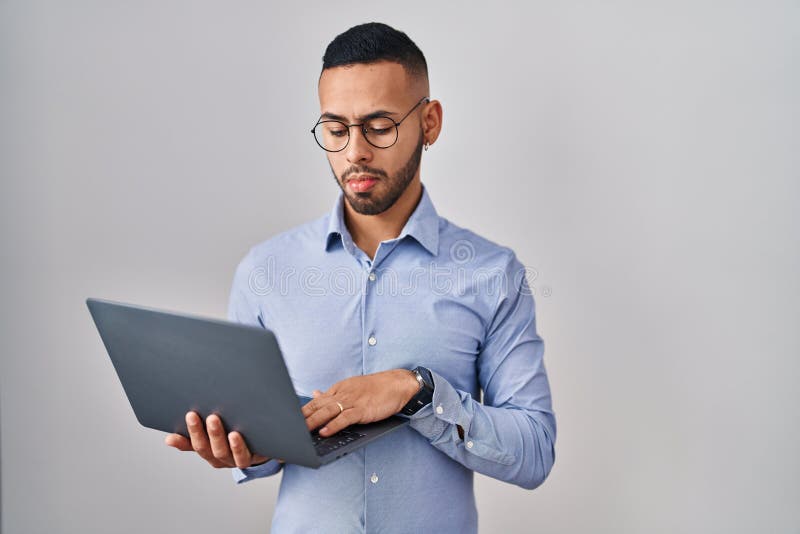Young Hispanic Man Working Using Computer Laptop Depressed and Worry ...