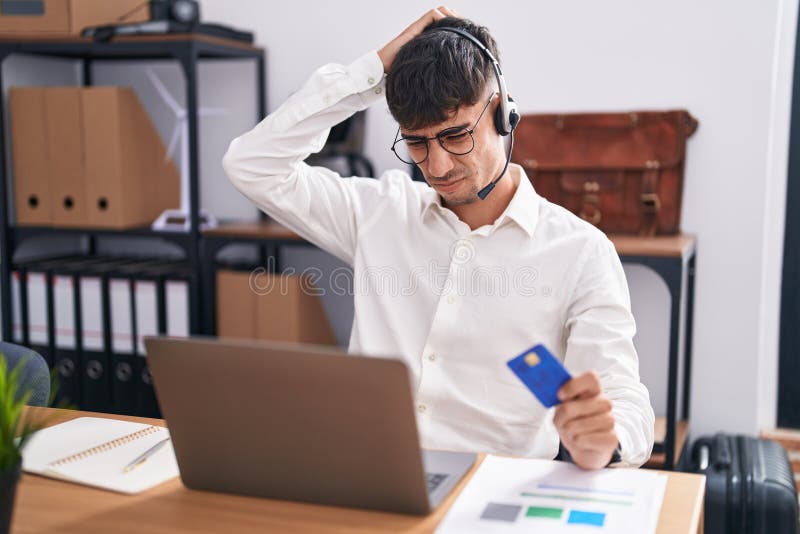 Young Hispanic Man Working Using Computer Laptop Holding Credit Card ...