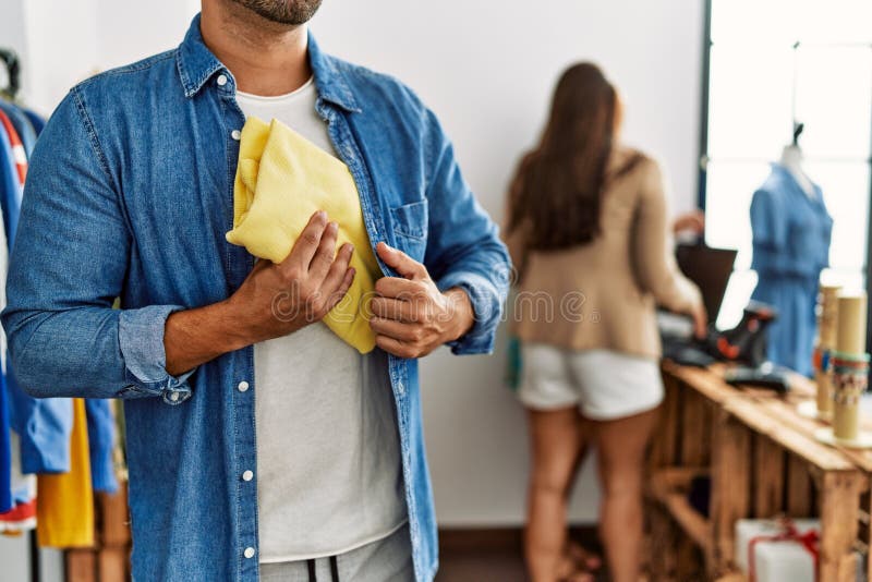 Young Hispanic Robber Man Stealing Shirt at Clothes Store Stock Image ...
