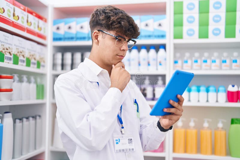 Young Hispanic Teenager Pharmacist Using Computer Holding Pills Bottle ...