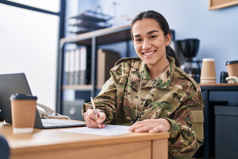 Young Hispanic Woman Army Soldier Using Laptop Writing on Document at ...