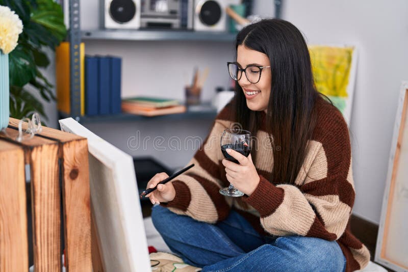 Young Hispanic Woman Artist Drinking Wine Drawing at Art Studio Stock ...