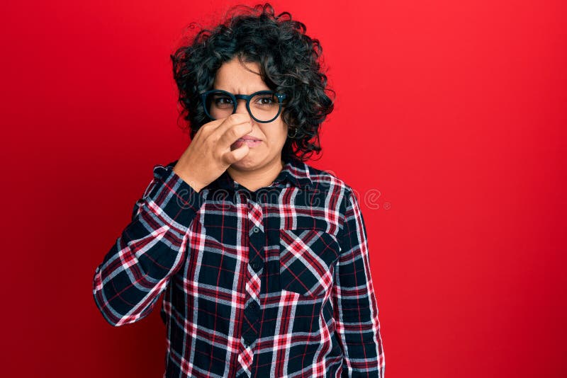 Young Hispanic Woman With Curly Hair Wearing Casual Clothes And Glasses