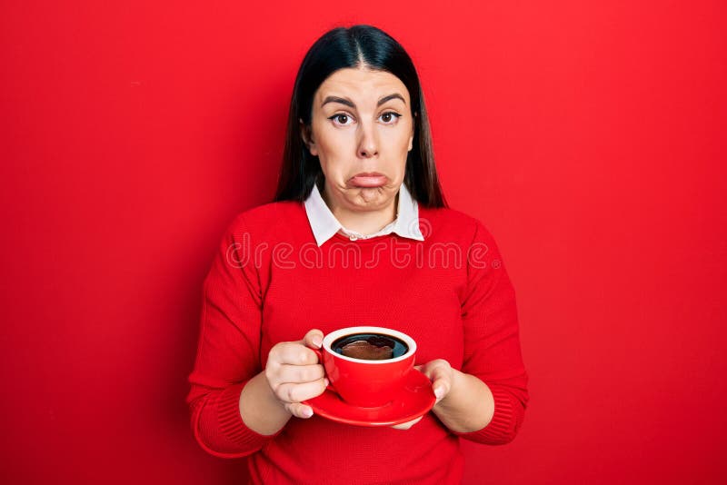 Young Hispanic Woman Drinking a Cup of Coffee Depressed and Worry for ...