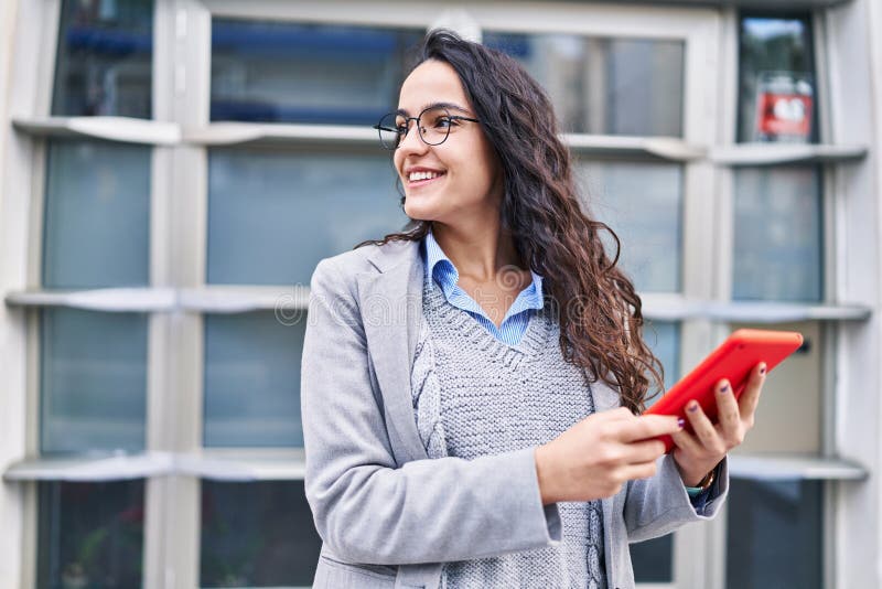 Young Hispanic Woman Executive Using Touchpad Standing at Street Stock ...