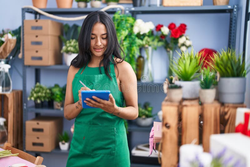 Young Hispanic Woman Florist Smiling Confident Using Touchpad at ... Young Hispanic Woman Florist Smiling Confident Using Touchpad at ...