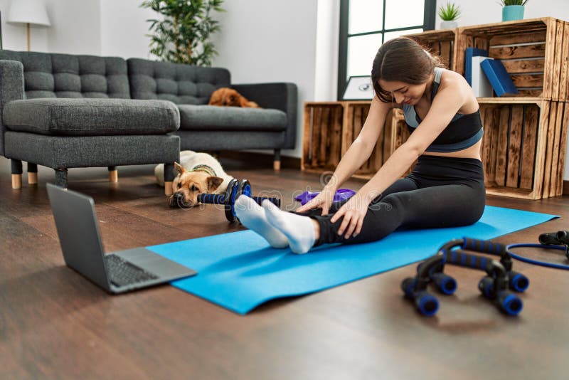 Young Hispanic Woman Having Online Stretching Class at Home Stock Image ...