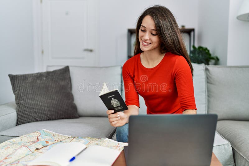 Young Hispanic Woman Holding Canada Passport Looking Map at Home Stock ...
