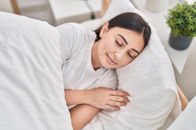Young Hispanic Woman Lying on Bed Sleeping at Bedroom Stock Image ...