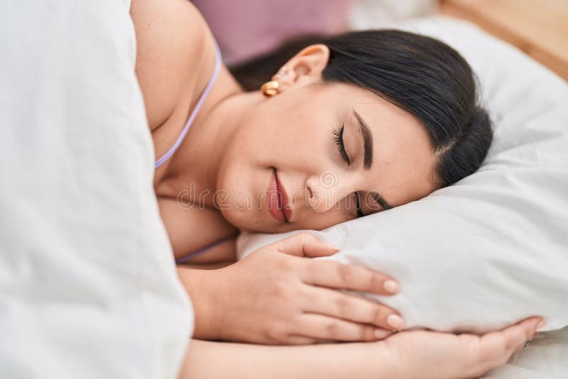 Young Hispanic Woman Lying on Bed Sleeping at Bedroom Stock Photo ...