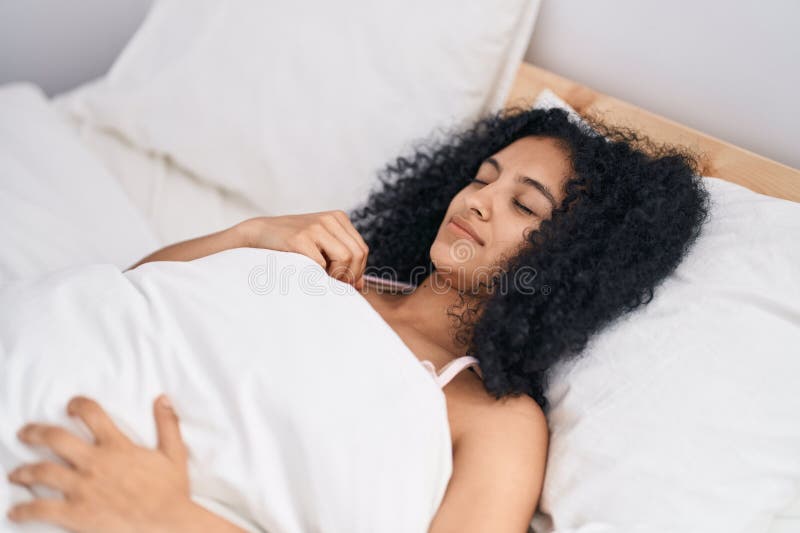 Young Hispanic Woman Lying on Bed Sleeping at Bedroom Stock Image ...