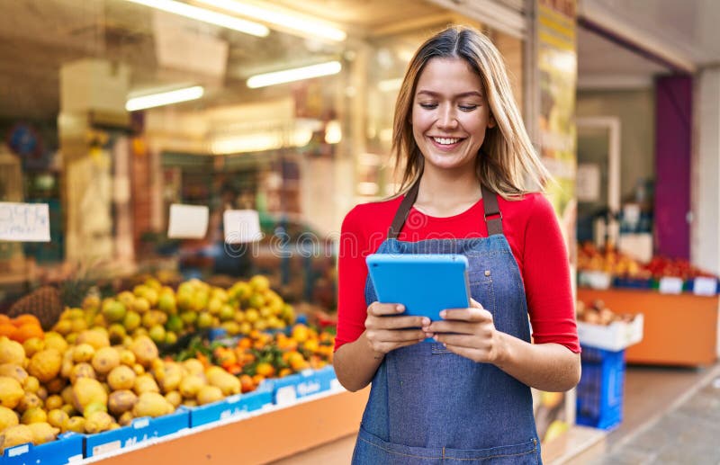 Young Hispanic Woman Shop Assistant Using Touchpad at Fruit Market ...