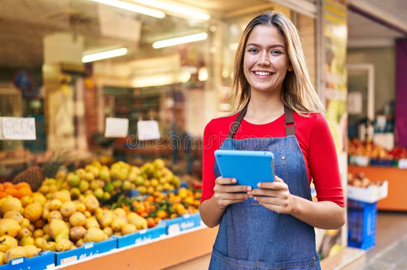 Young Hispanic Woman Shop Assistant Using Touchpad at Fruit Market ...