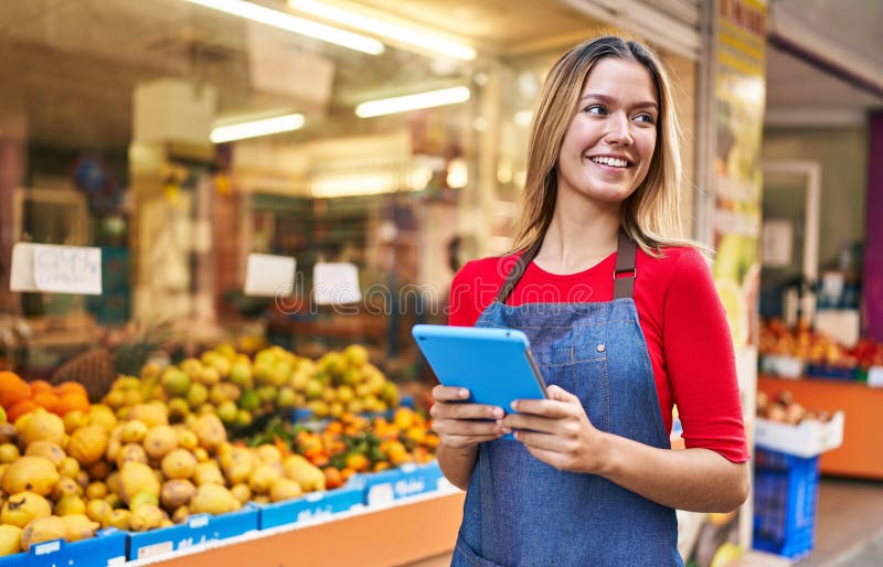 Young Hispanic Woman Shop Assistant Using Touchpad at Fruit Market ...