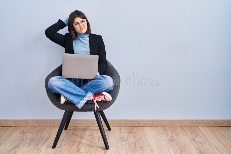 Young Hispanic Woman Sitting on Chair Using Computer Laptop Confuse and ...