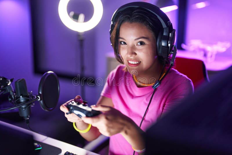 Young Hispanic Woman Streamer Playing Video Game Using Joystick at ...
