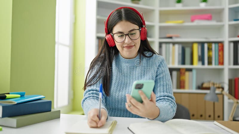 Young Hispanic Woman Student Using Smartphone Wearing Headphones Taking ...