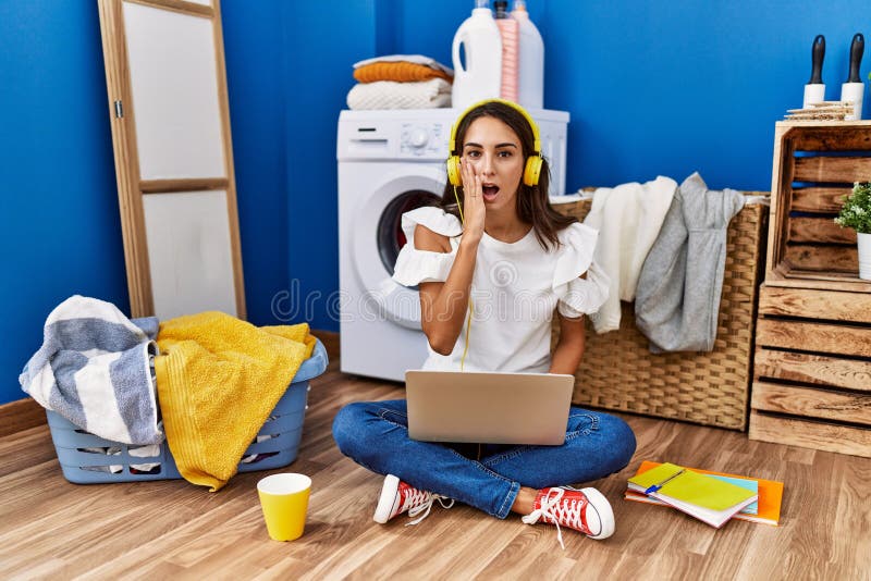Young Hispanic Woman Studying while Waiting for Laundry Afraid and ...