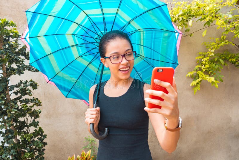 Young Hispanic Woman Viewing Something on a Mobile Phone and Feeling ...