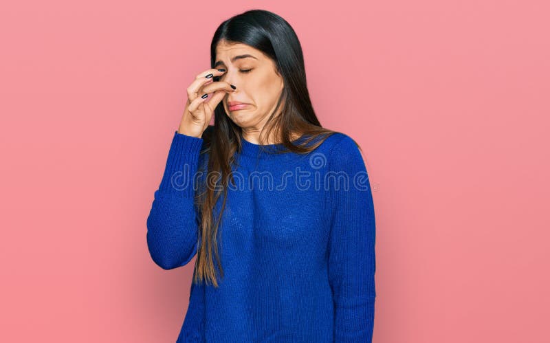 Young Hispanic Woman Wearing Casual Clothes Smelling Something Stinky