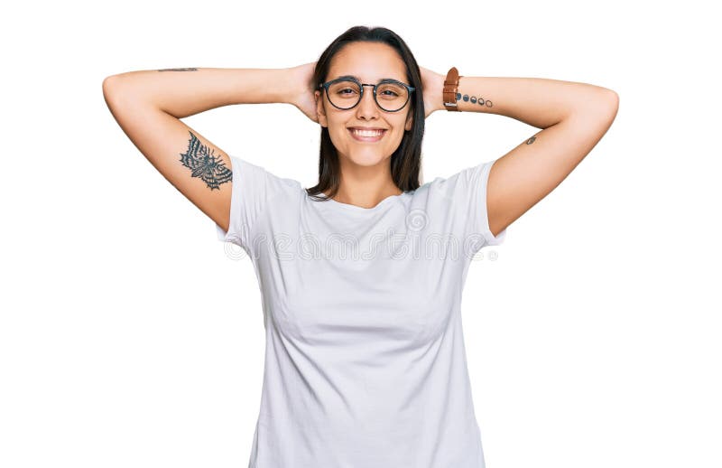 Young Hispanic Woman Wearing Casual White T Shirt Relaxing And
