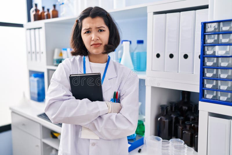 Young Hispanic Woman Working at Scientist Laboratory Clueless and ...